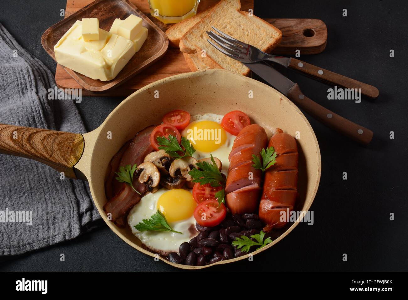 Traditional full English breakfast with bacon, fried eggs, sausages ...