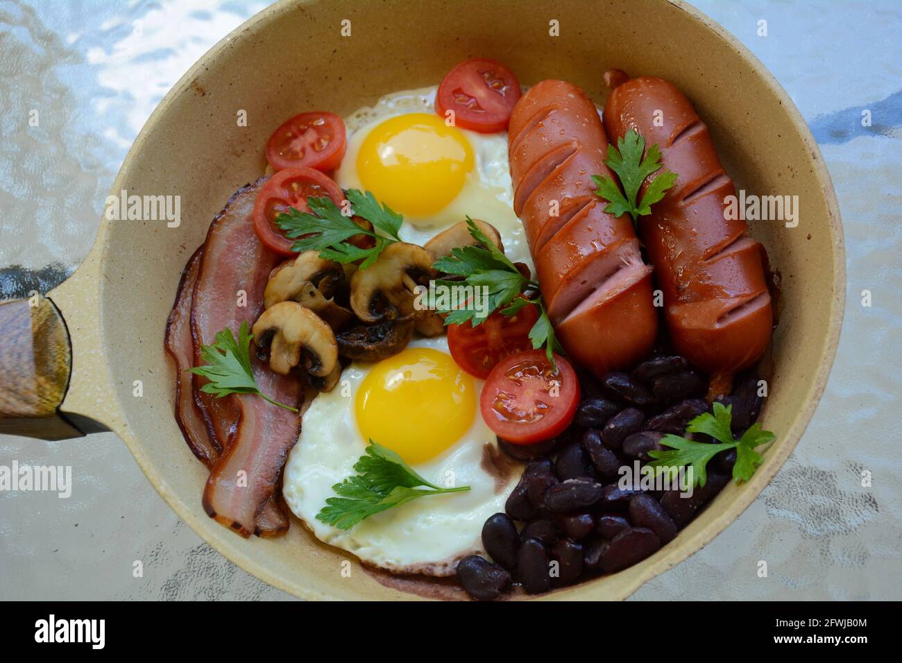 Traditional full English breakfast with bacon, fried eggs, sausages ...