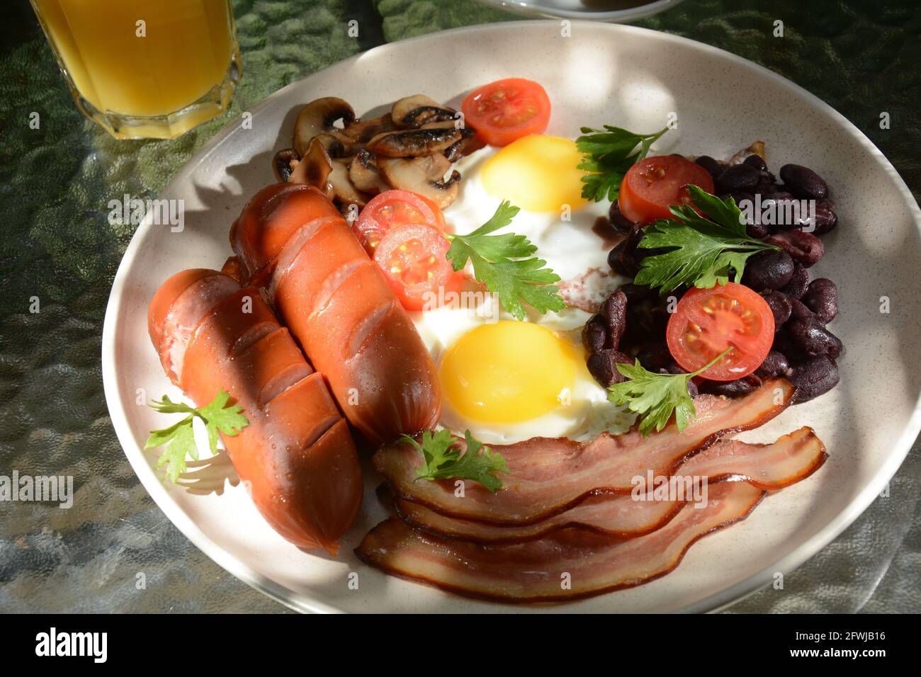Traditional full English breakfast with bacon, fried eggs, sausages ...