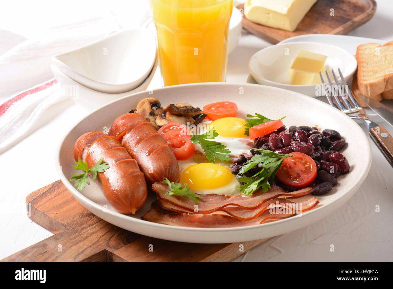 Traditional full English breakfast with bacon, fried eggs, sausages ...