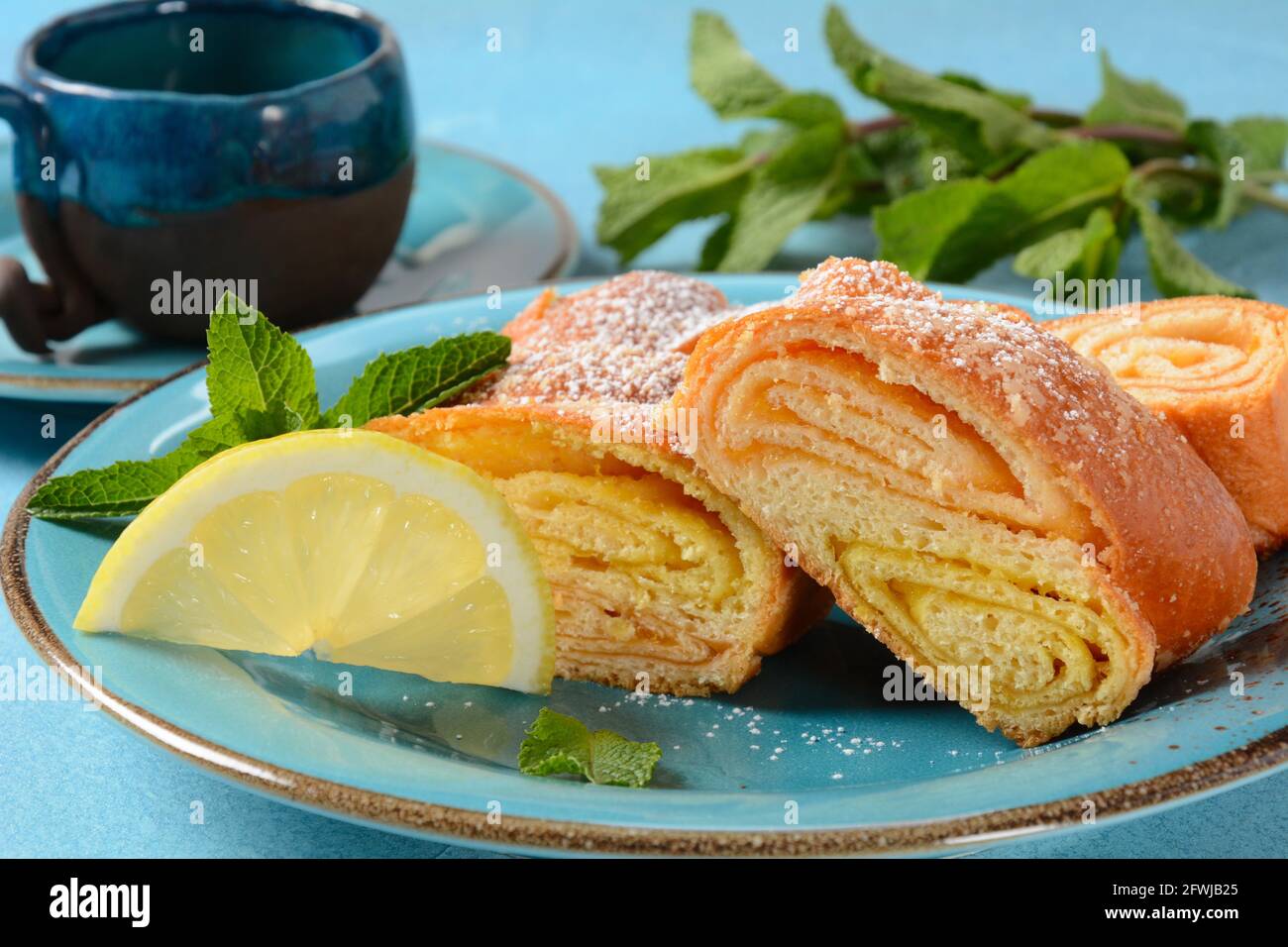 Austrian strudel with lemon and mint and with powdered sugar on a plate ...