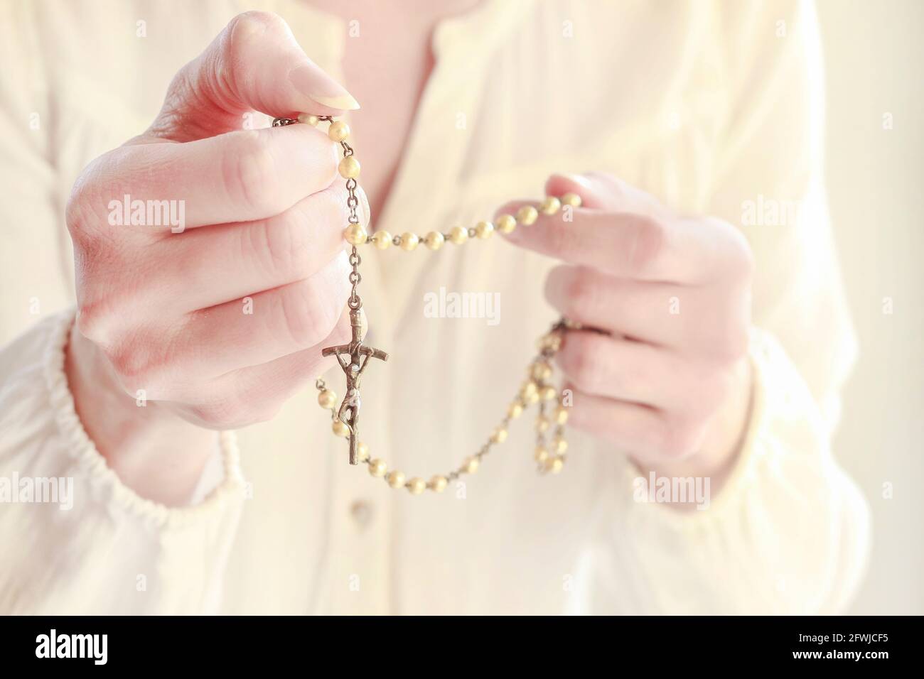 White rosary in beautiful hands. Graphic resources Stock Photo - Alamy
