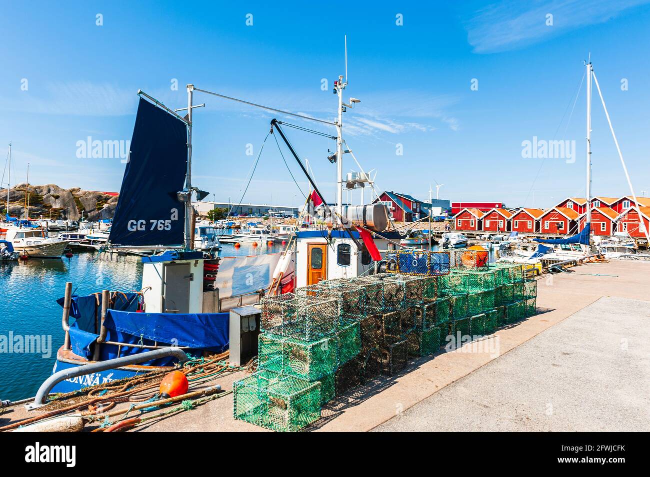 RÖNNÄNG, SWEDEN - JULY 5, 2008: Lobster pots in front of fishing boat ...