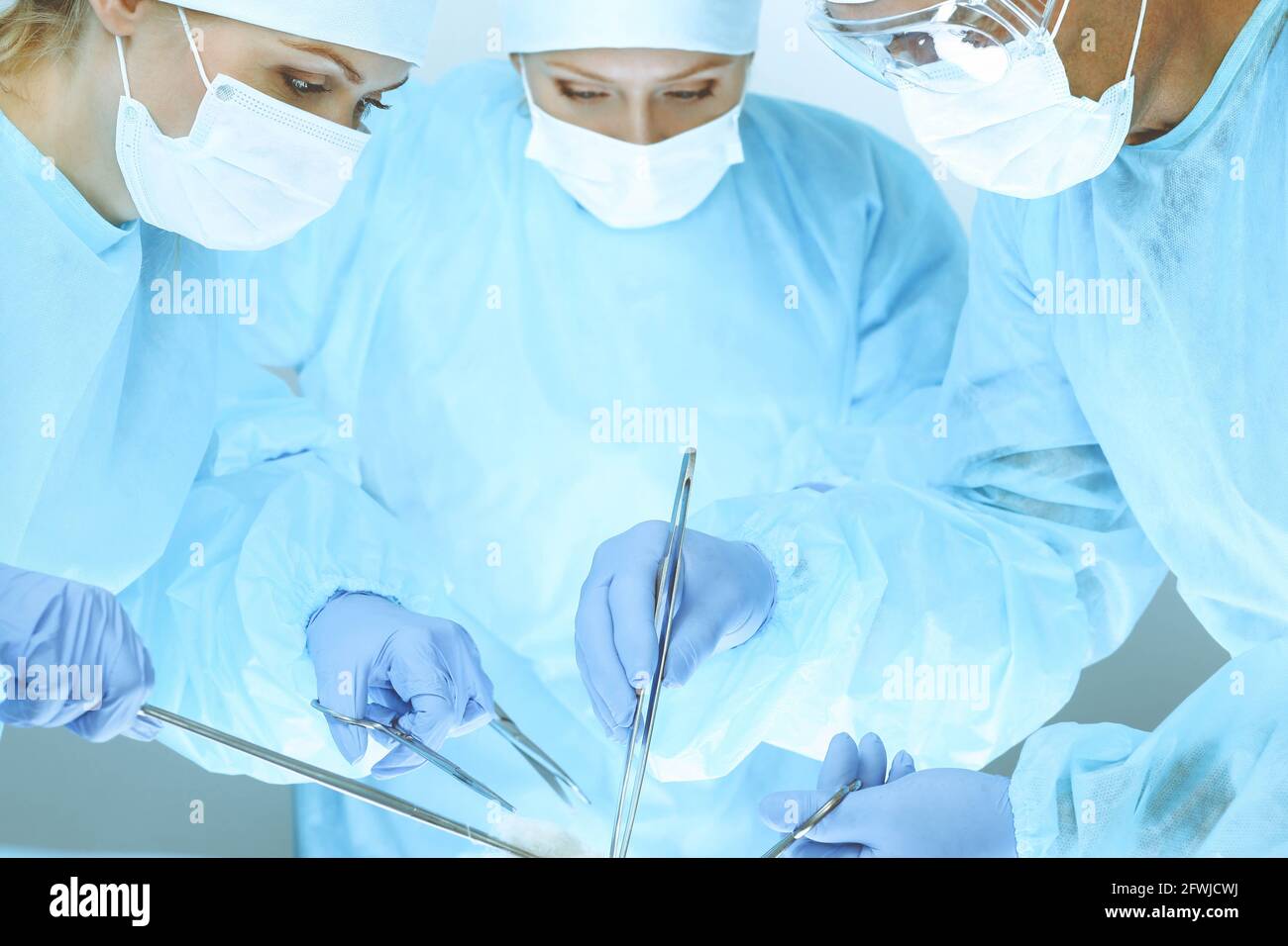 A group of surgeons is operating at the hospital. Health care concept ...