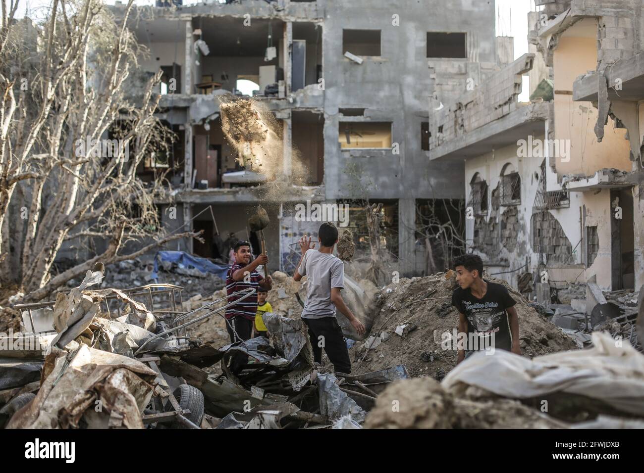 Palestinian kids play among the rubble of their destroyed homes after ...