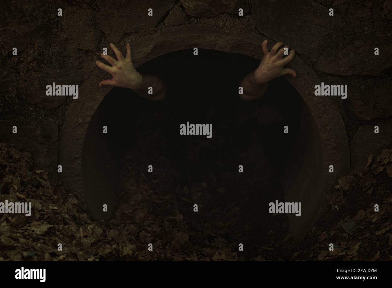 Small dark tunnel opening with two hands with twisted fingers poking ...