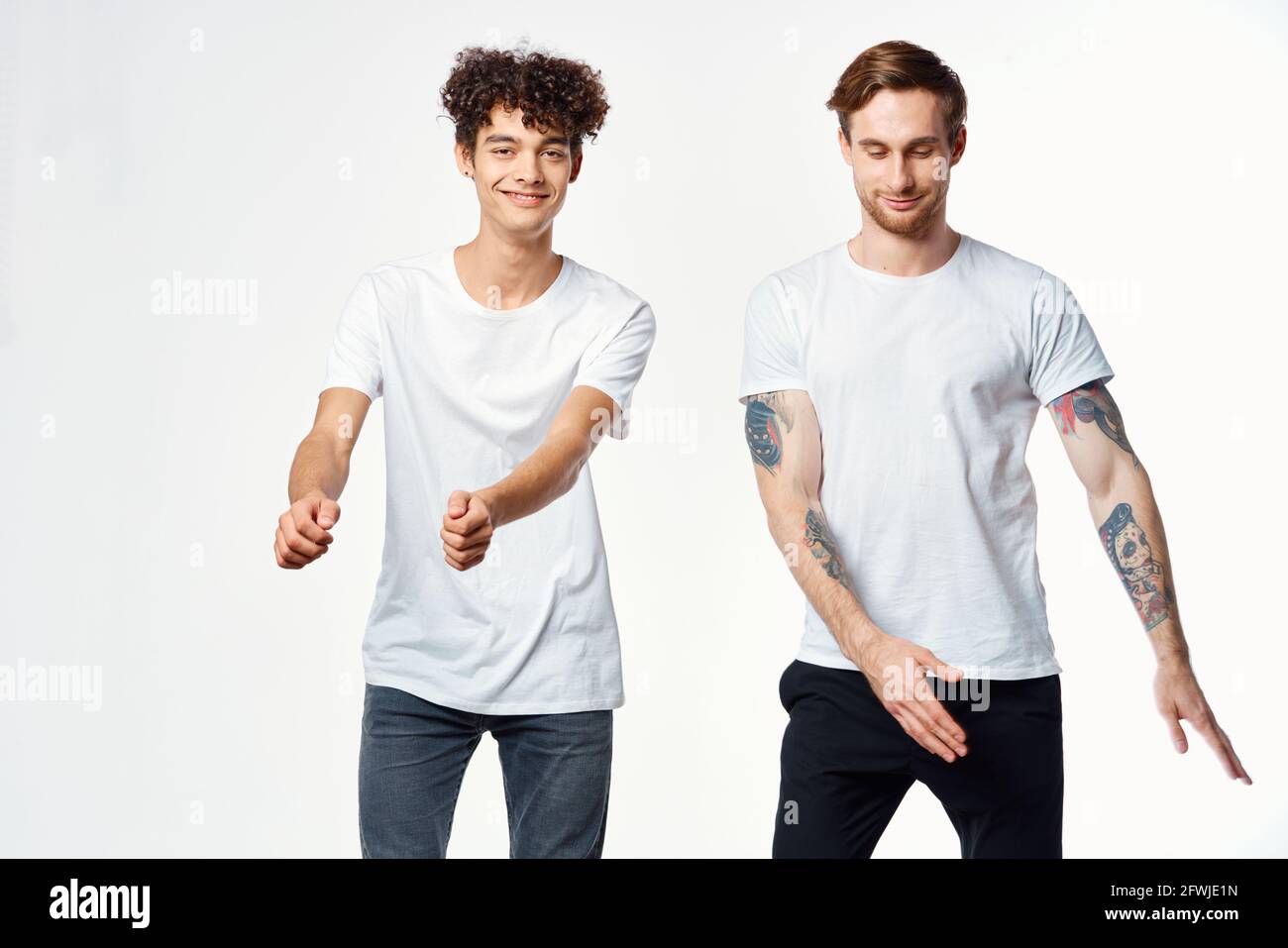 two funny friends in white t-shirts laughing positive emotions Stock ...