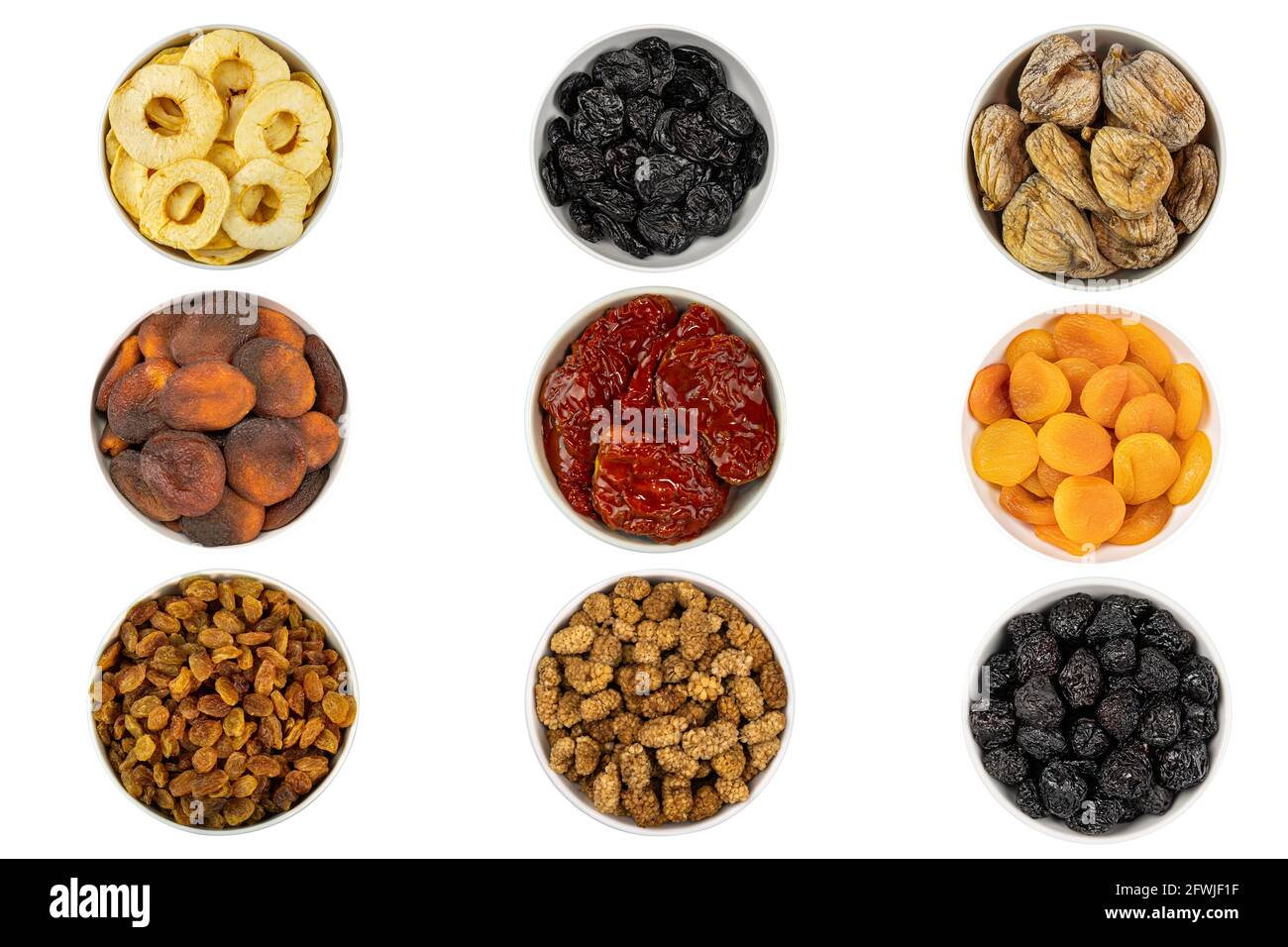 assorted dried fruits and berries snacks on white background dry cherry ...