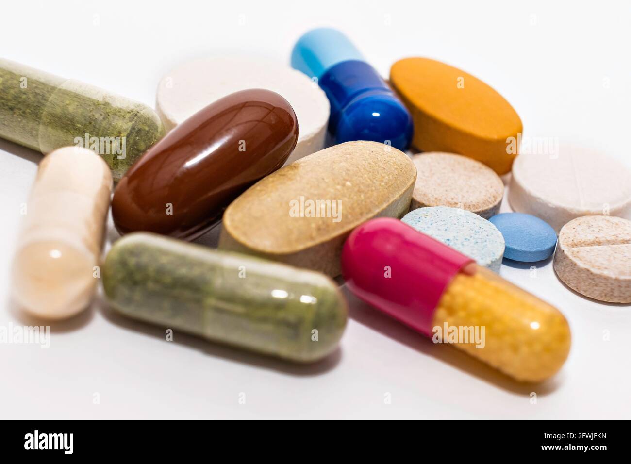 Close-up colorful assorted soft capsules pill vitamin tablet blue pink ...