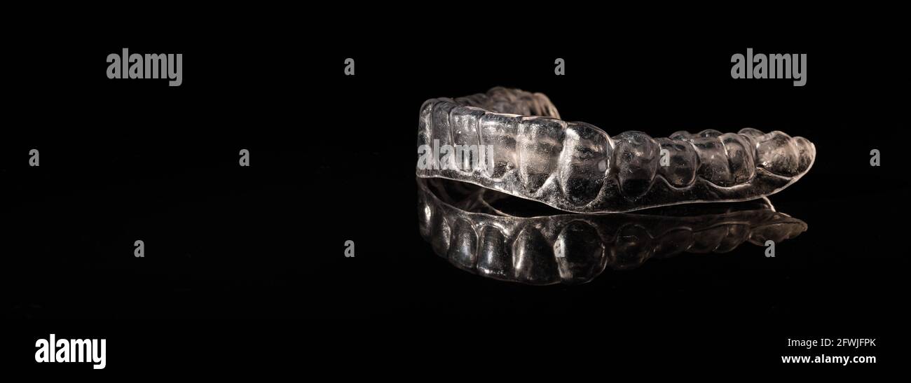 Removable plastic retainers for bite correction on a black background ...