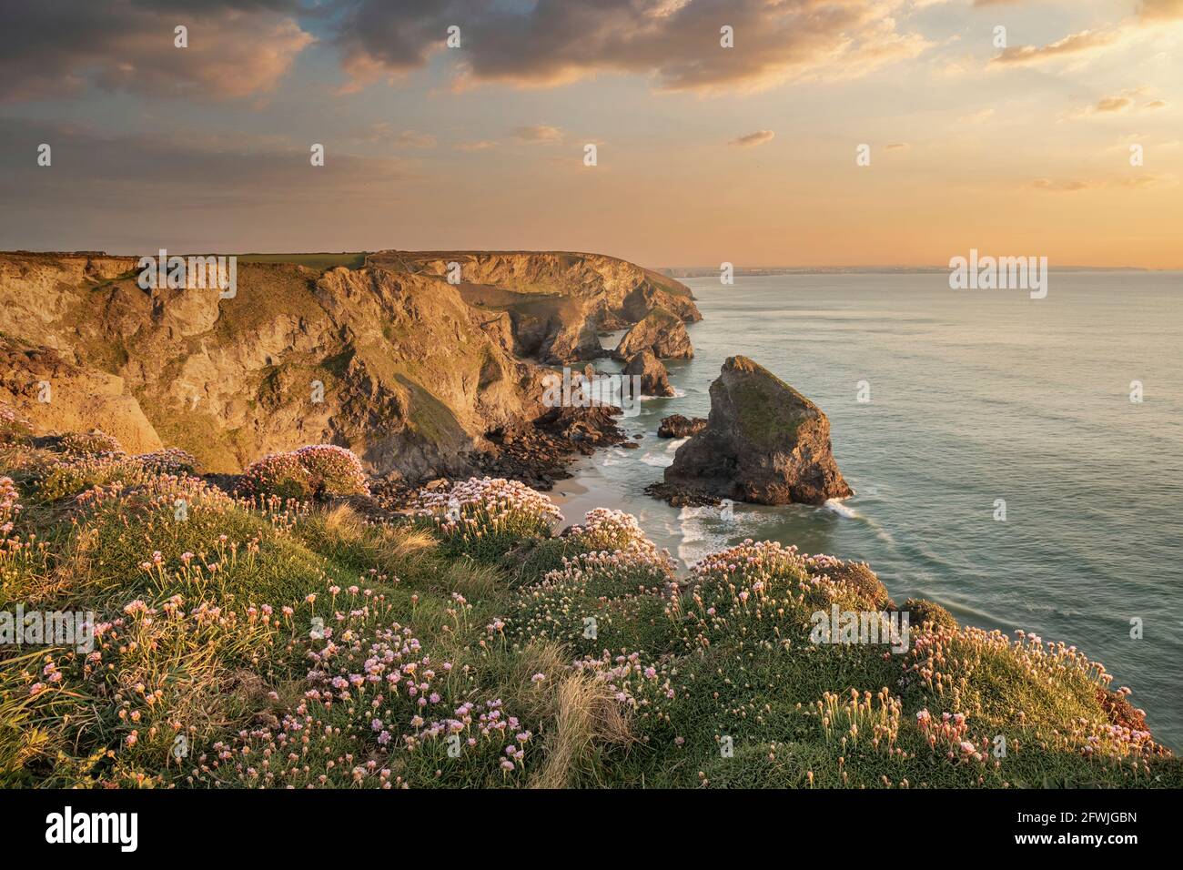 Stunning landscape image during golden hour on Cornwall coastline at ...