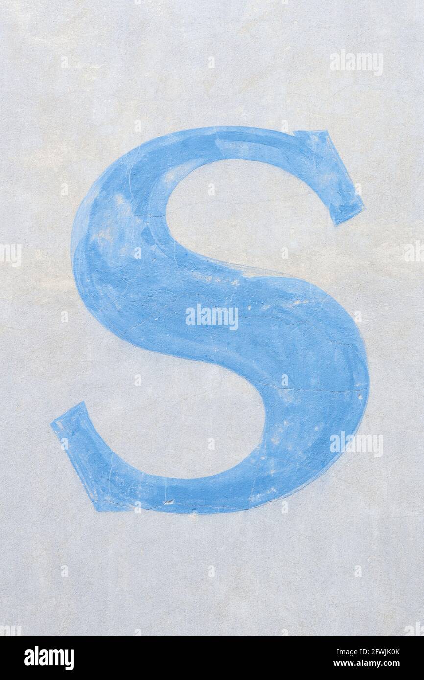Light blue letter S in serif font on a light grey wall Stock Photo - Alamy