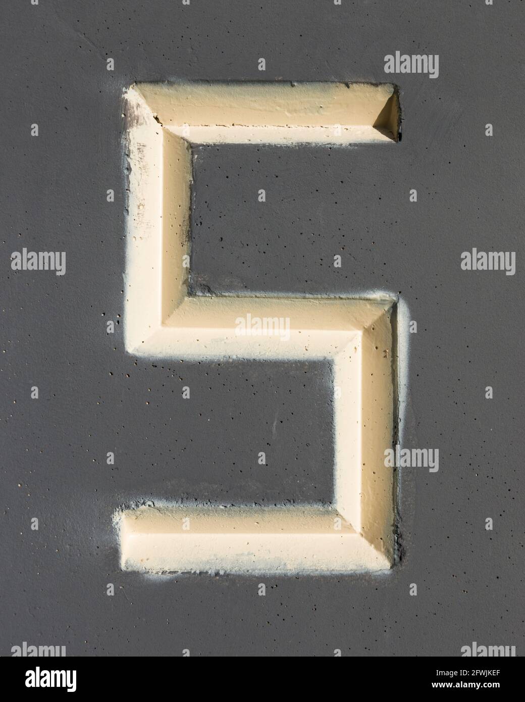 Beige letter S inverse relief in grey painted concrete Stock Photo - Alamy