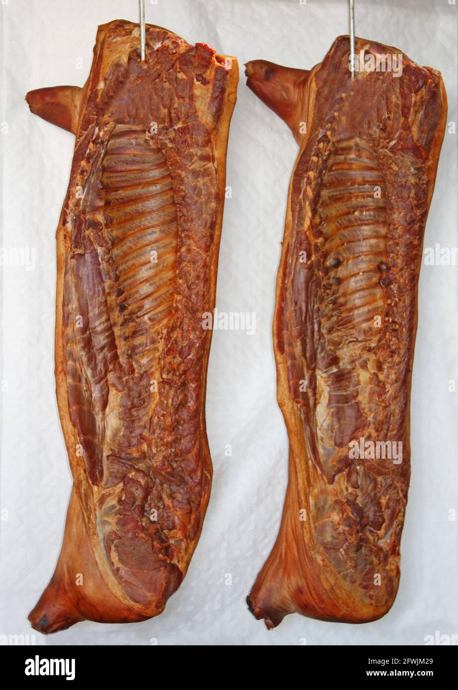 Two Hanging Prepared Bacon Carcasses from Pigs Stock Photo - Alamy