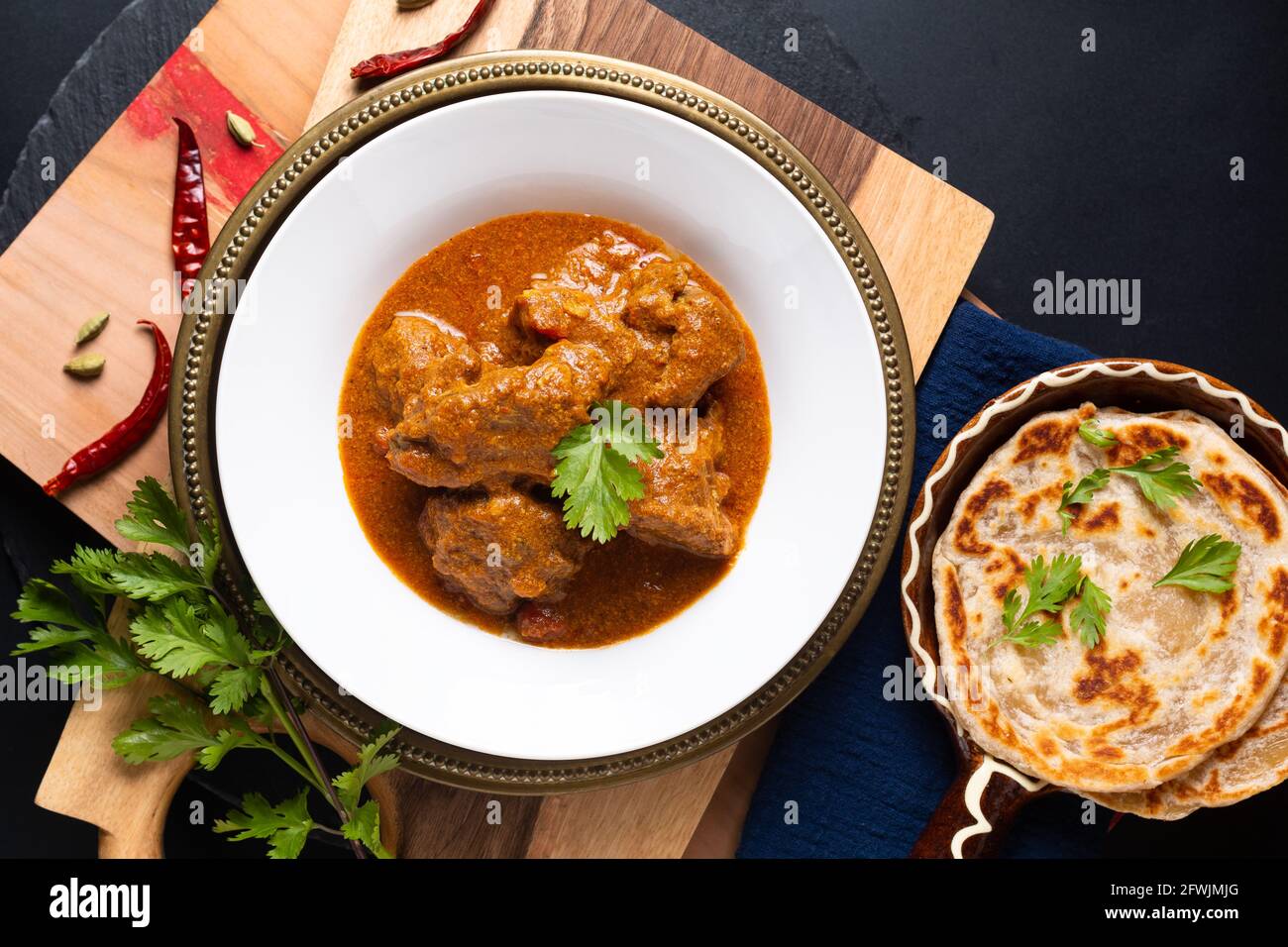 Food concept Homemade beef masala curry and roti paratha on wooden ...