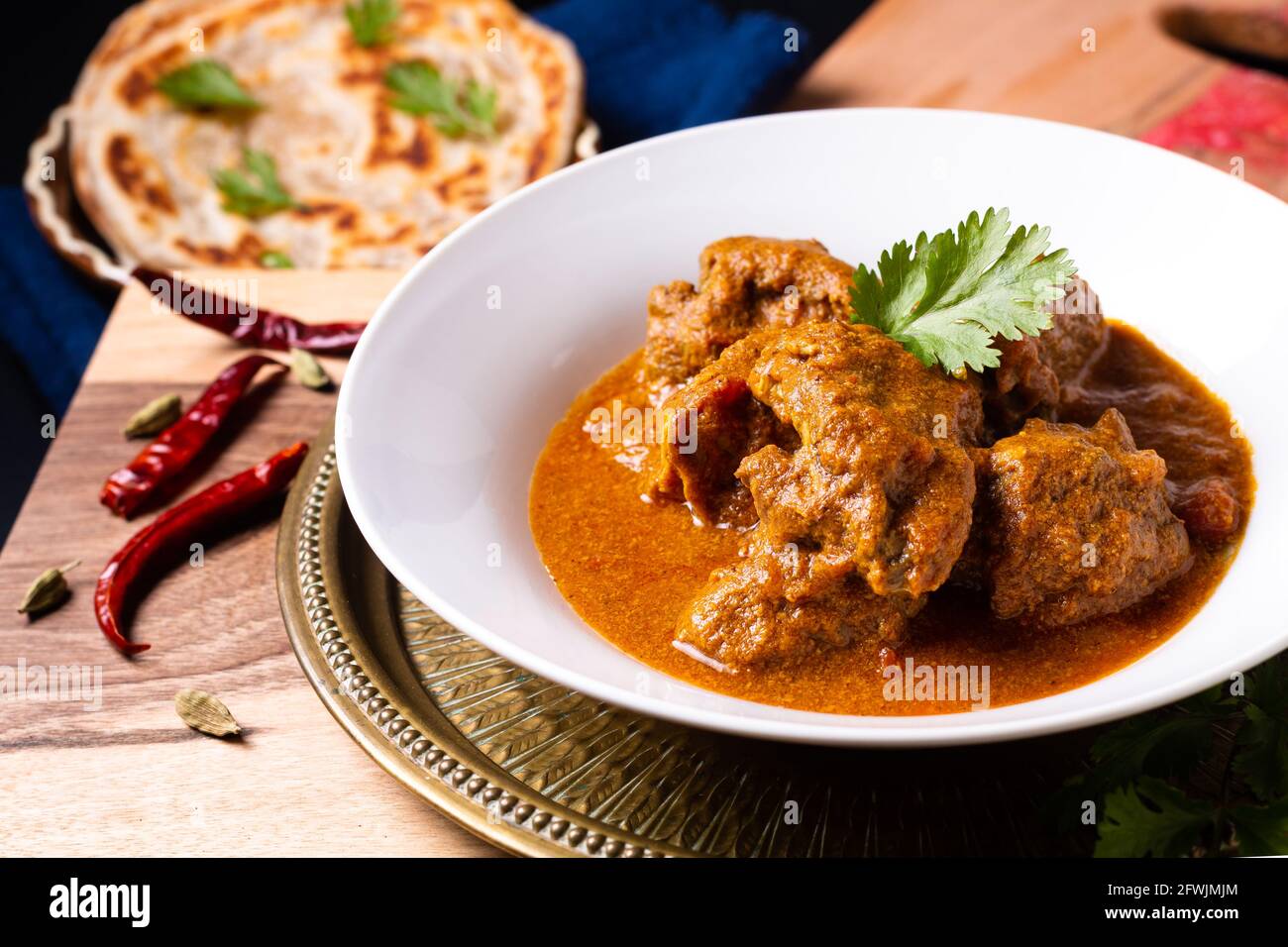 Food concept Homemade beef masala curry and roti paratha on wooden ...