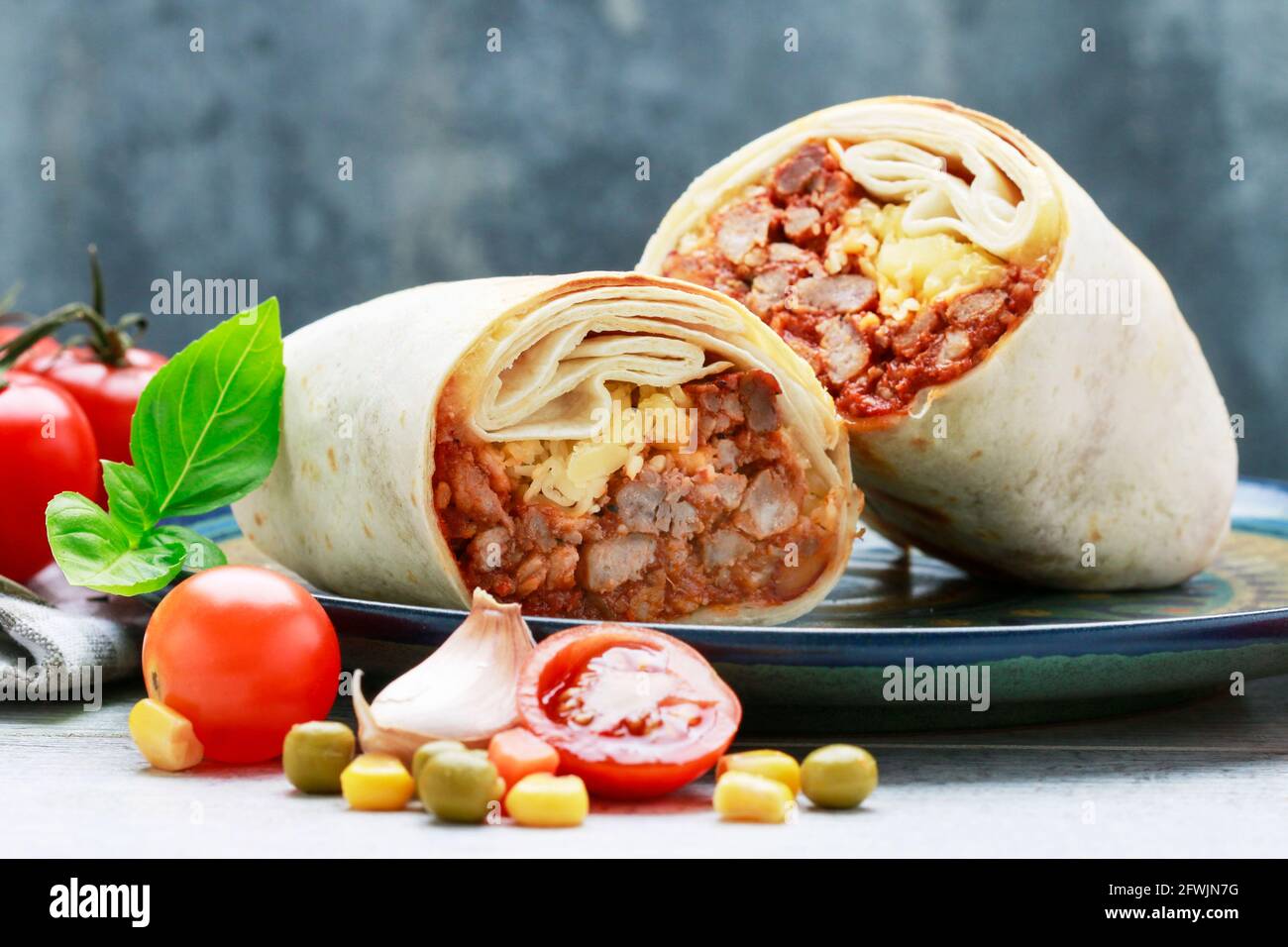 A burrito - mexican dish that consists of a flour tortilla with various ...