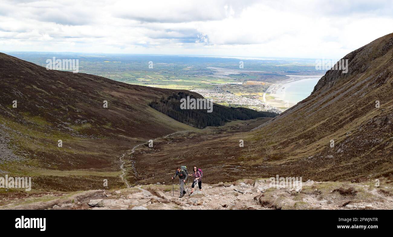 Walkers use the National Trust stone path on Slieve Donard mountain in ...