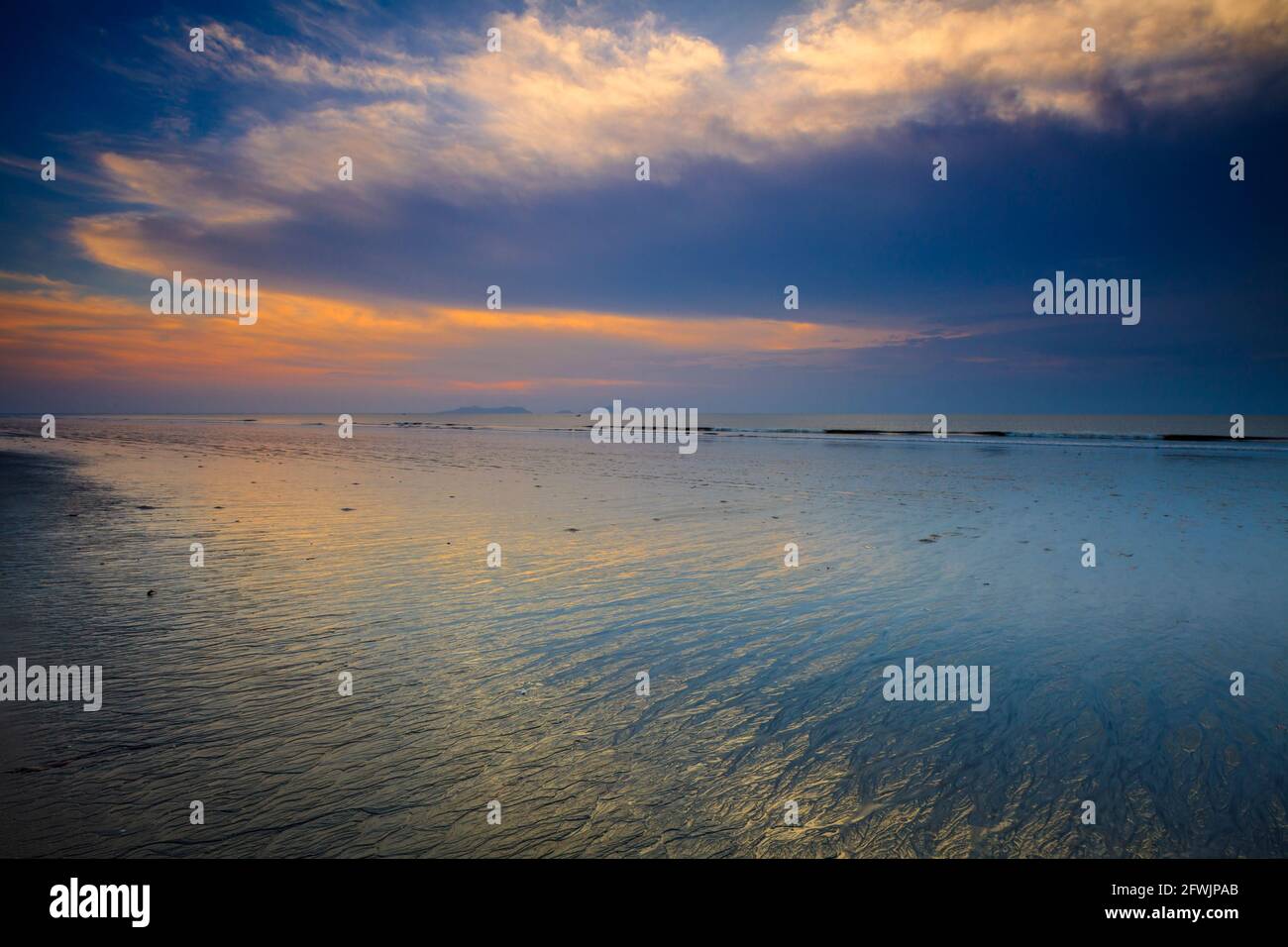 Coastal landscape with sunrise and wet sand at low tide at Punta Chame ...