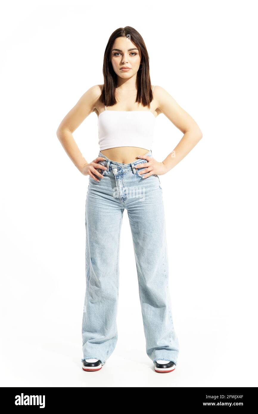 Cute and confident young stylish woman in jeans and summer top with ...