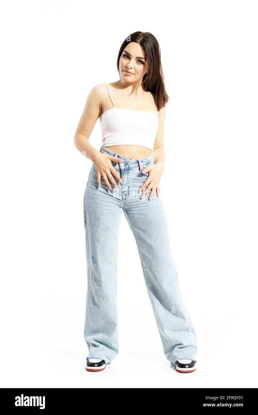 Smiling summer gen Z girl in casual clothes posing in white top and ...