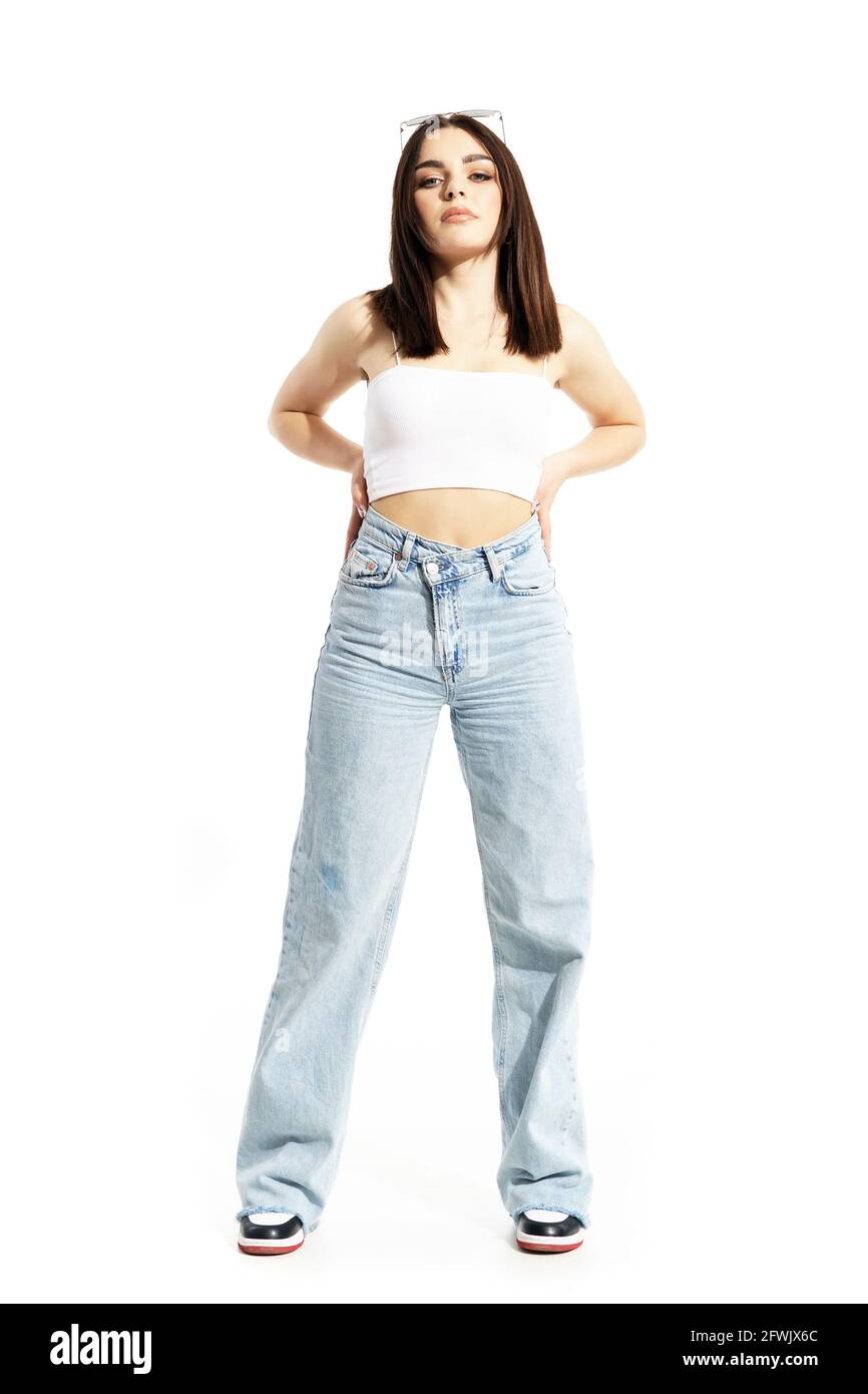 Beautiful summer girl in casual clothes posing with hands on hips with ...