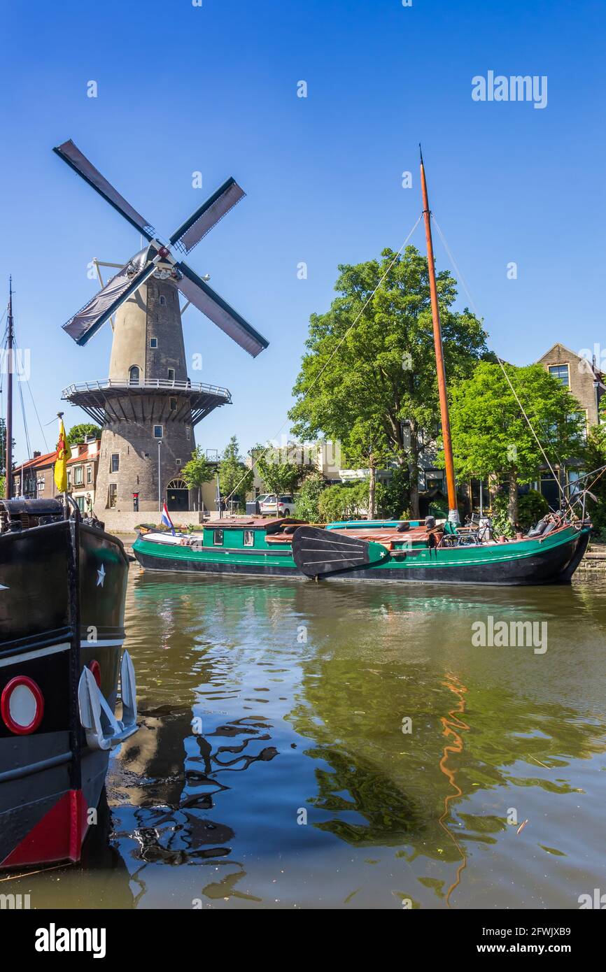 Harbor with traditional sailing ships and wind mill hi-res stock ...