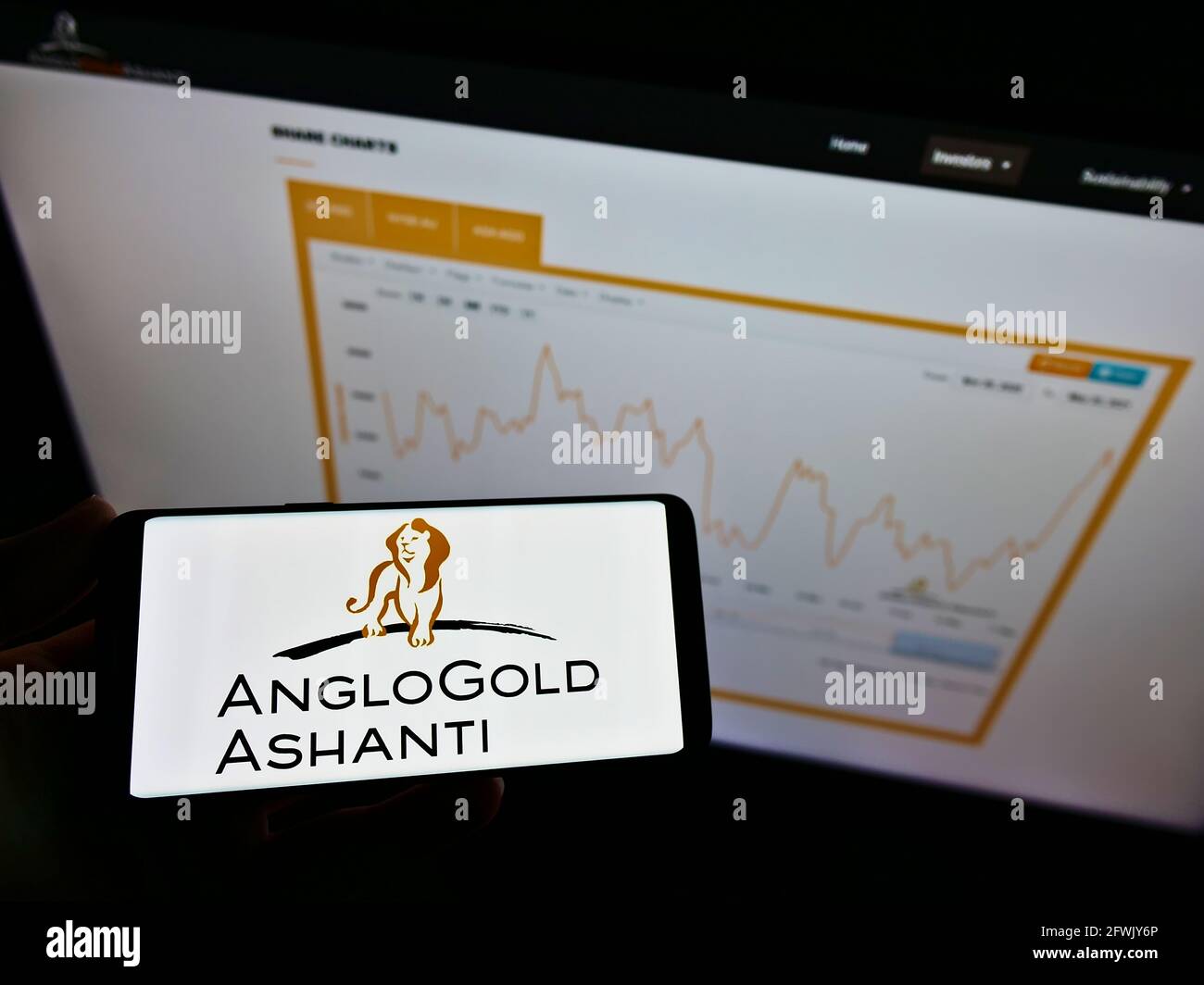 Person holding cellphone with logo of South African mining company ...