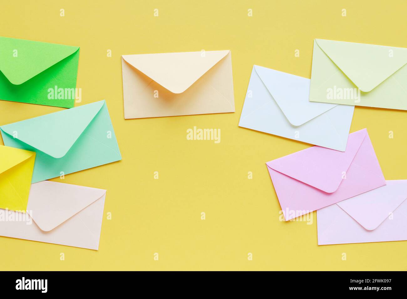 Colorful envelopes on yellow background, copy space Stock Photo - Alamy