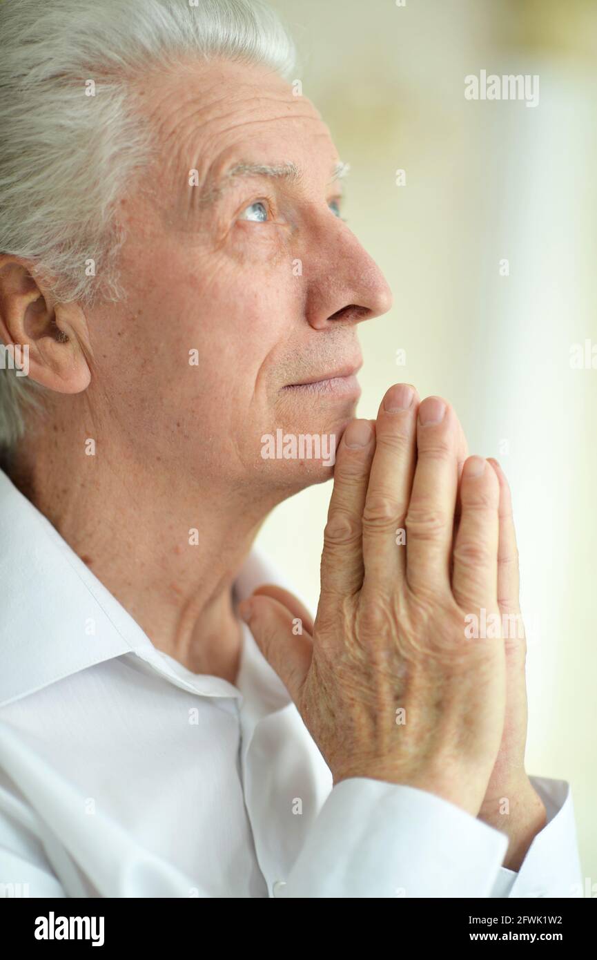 Handsome man home praying hi-res stock photography and images - Alamy