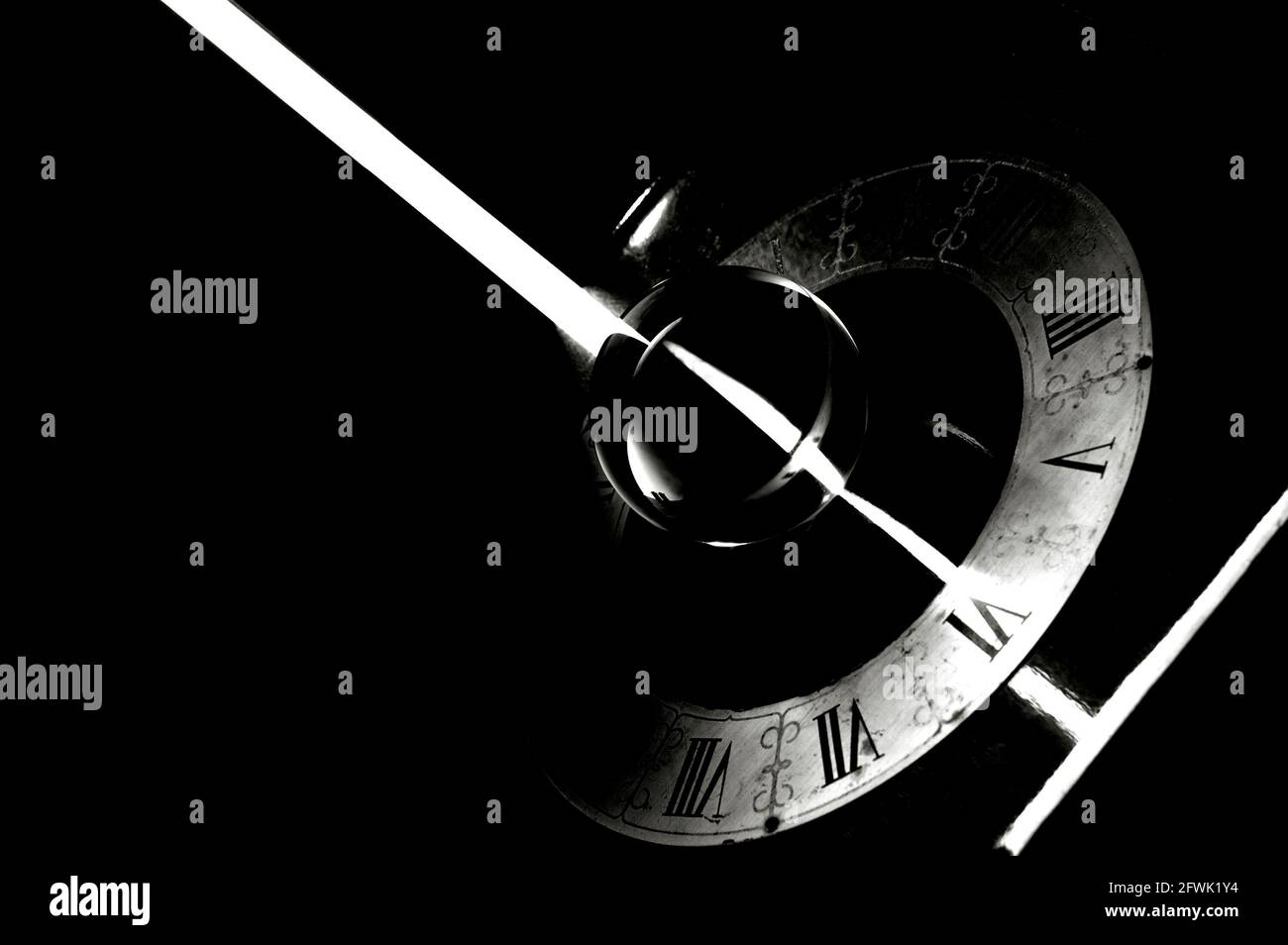 A vintage clock with a bright ray of light in black and white Stock ...