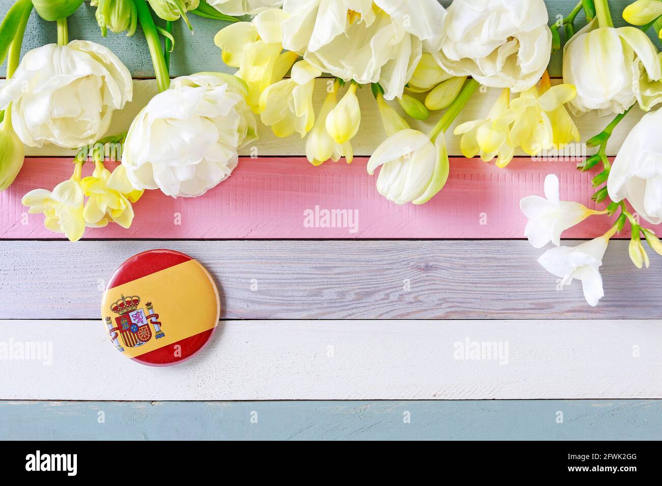 Spanish flag printed on button badge and beautiful flowers on striped ...