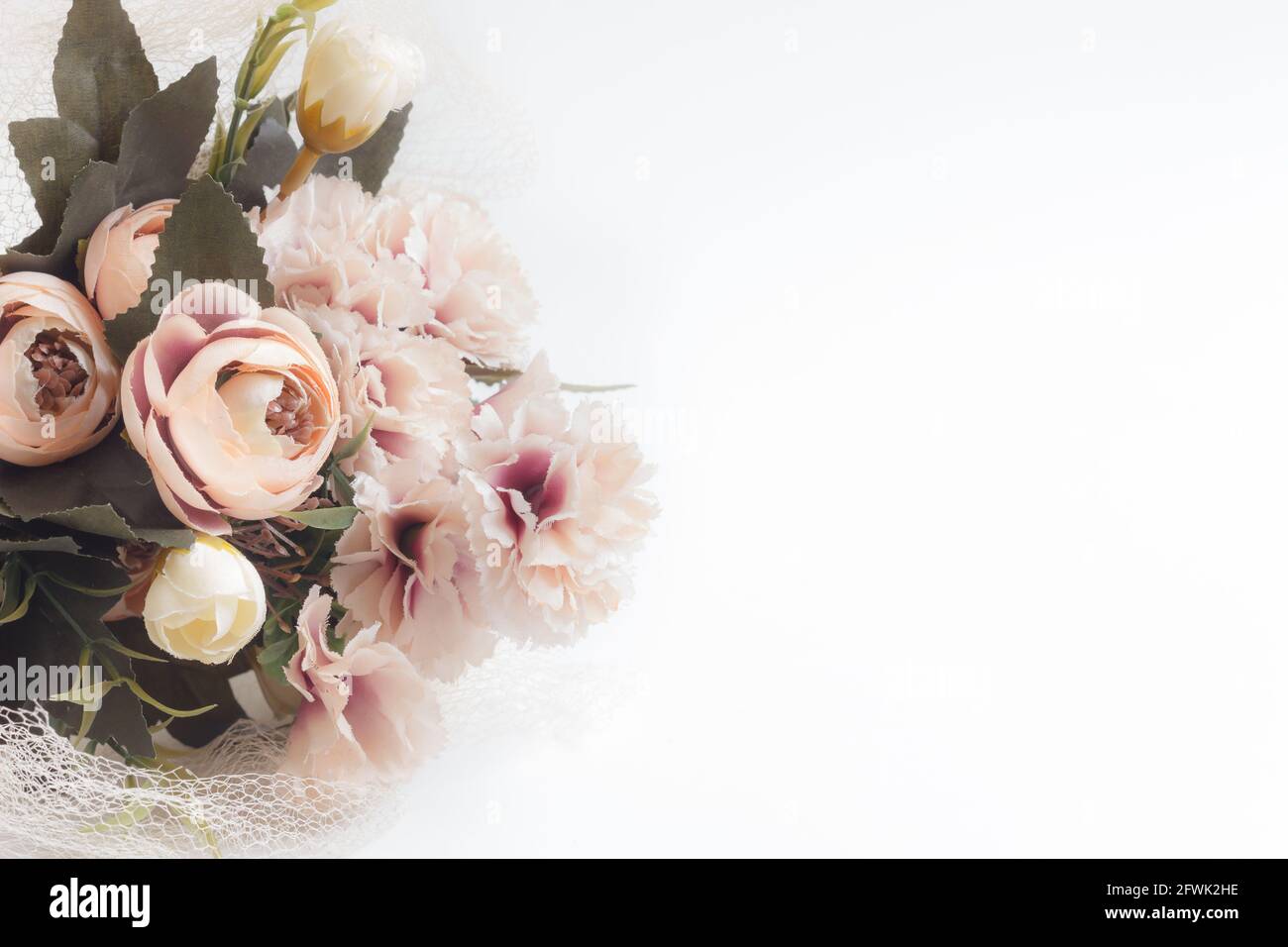 Artificial flower made of pink colors on a white background and ...