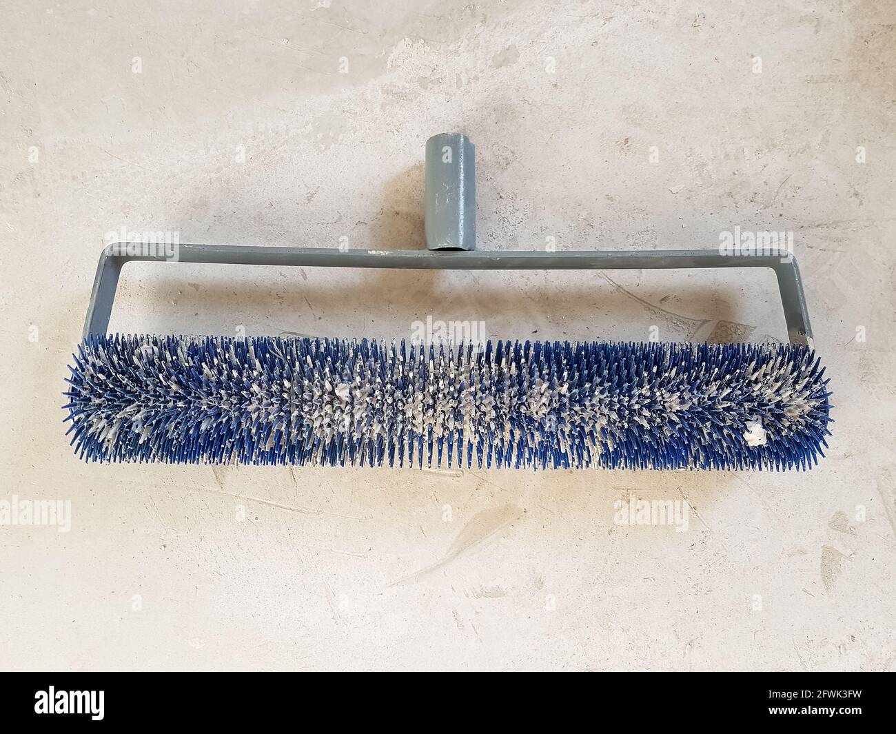 Spiked roller for self-leveling floor after usage Stock Photo - Alamy