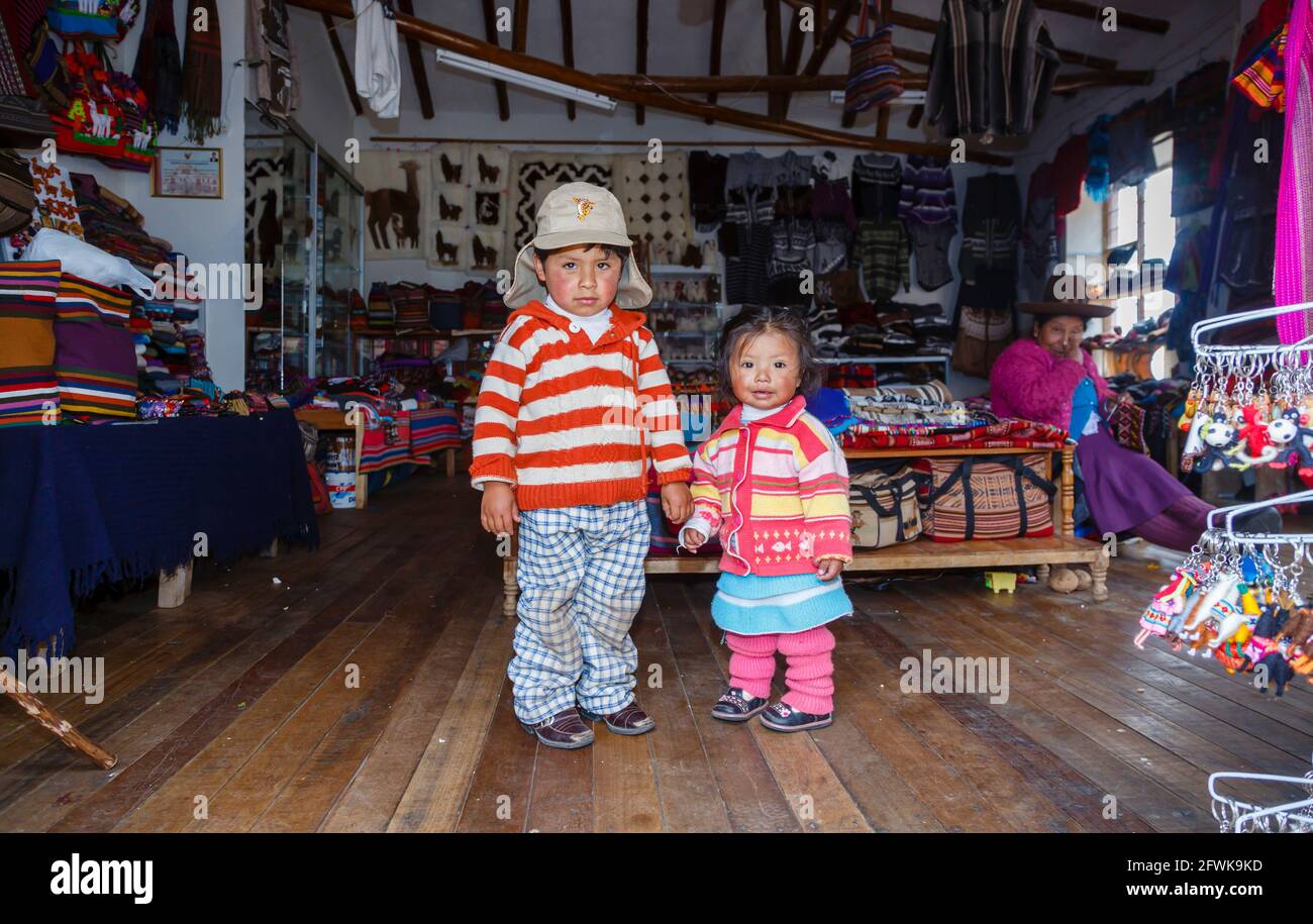 Cute local Quechua children in a shop in Chinchero, a small Andean ...