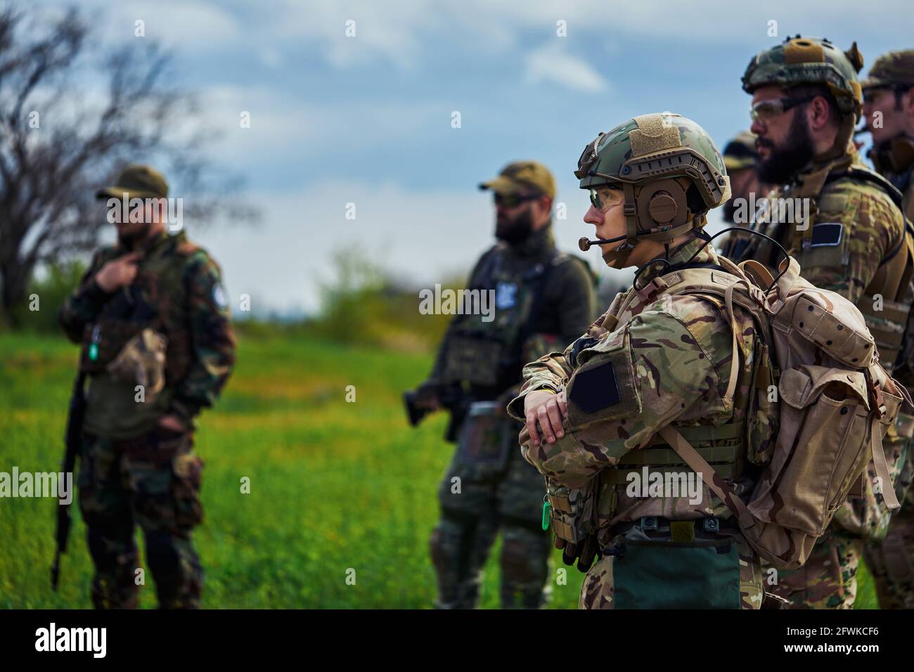 Group of airsoft players in uniform with weapons Stock Photo - Alamy