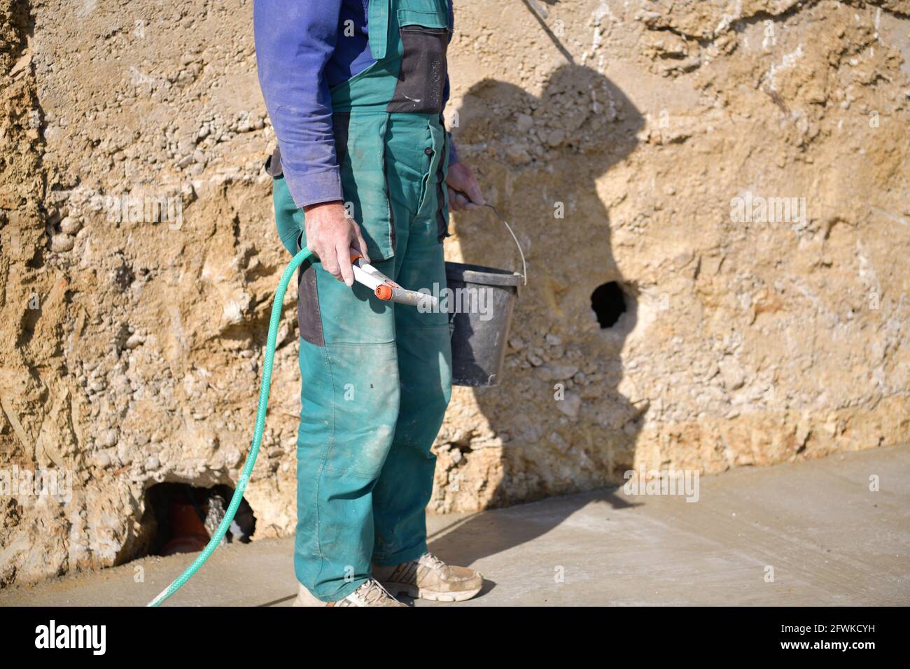 The mason pours fresh concrete poured on the foundation wall Stock ...
