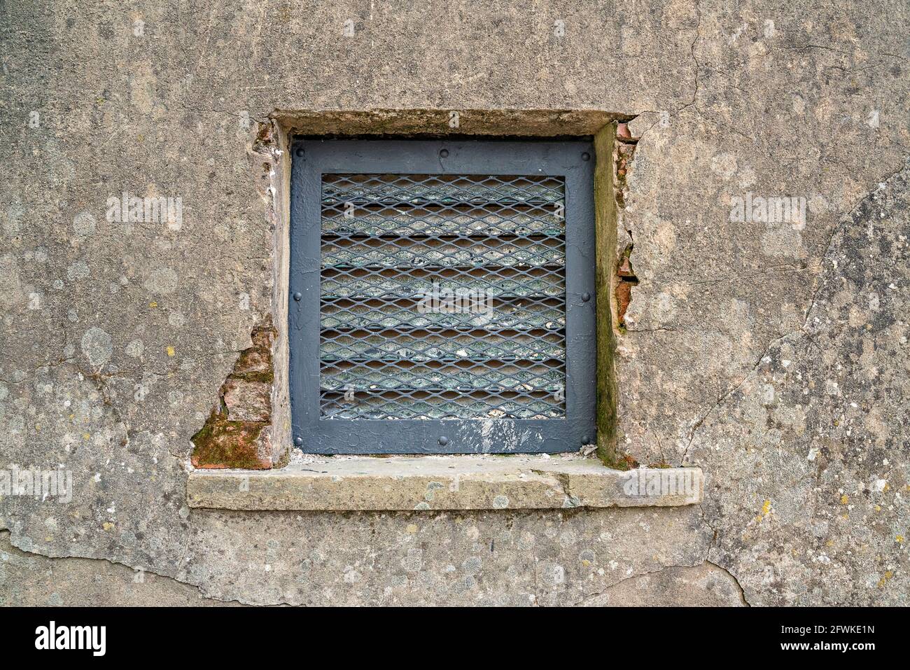 Wire mesh covered louvred window in old building Stock Photo - Alamy