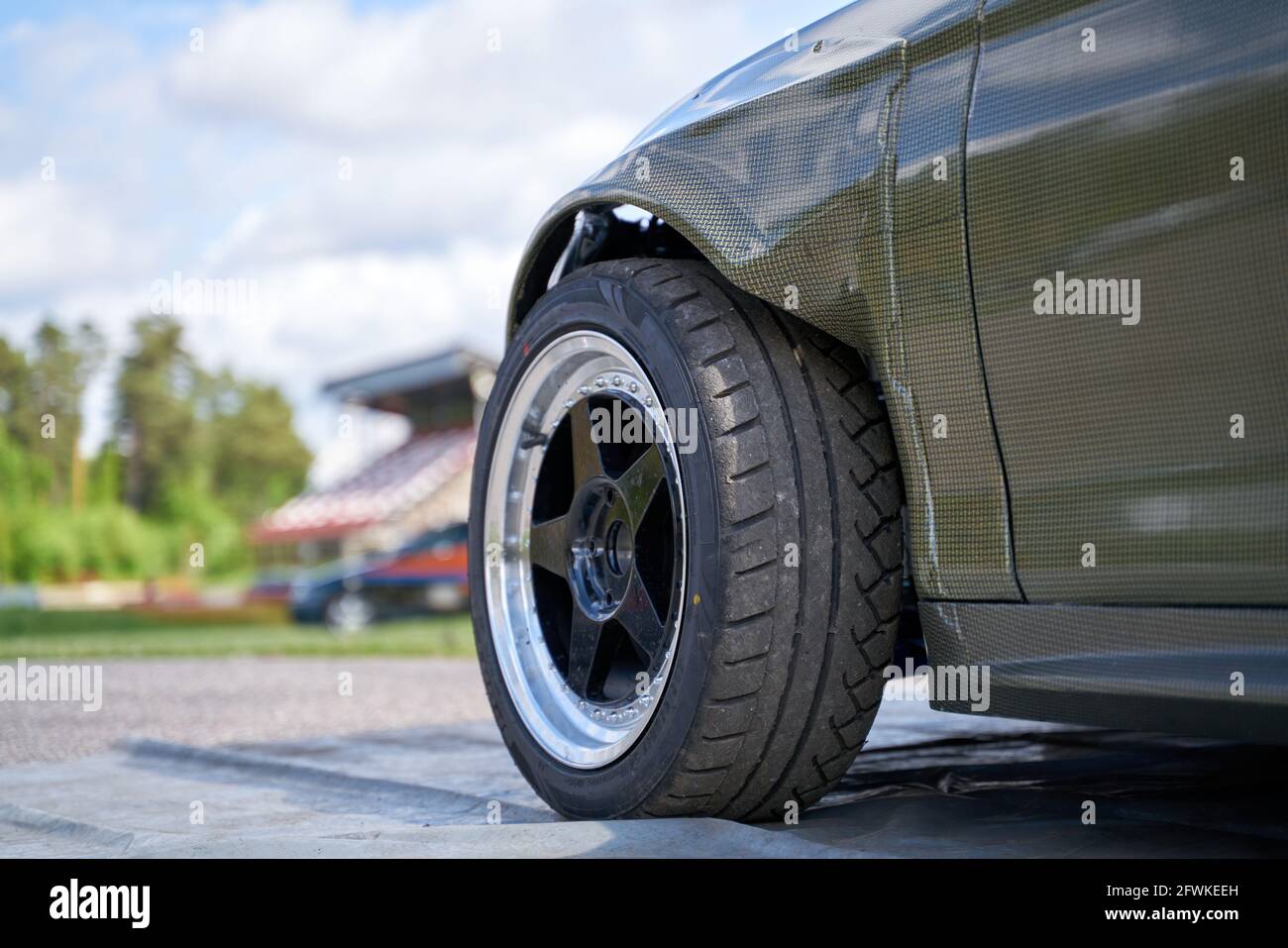 Rear side view front wheel of black car Stock Photo - Alamy