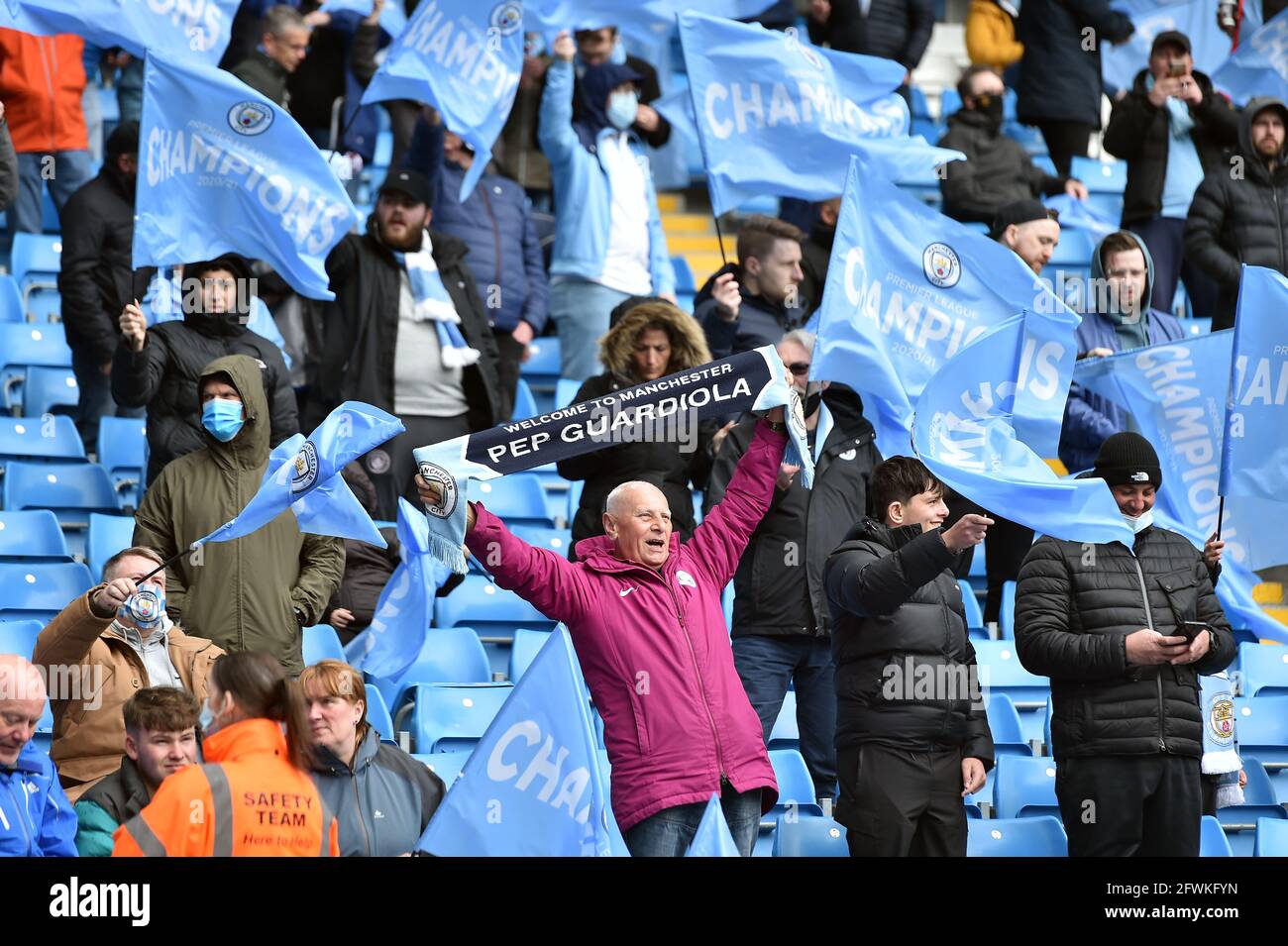 Manchester city fans wave flags in the stands hi-res stock photography ...