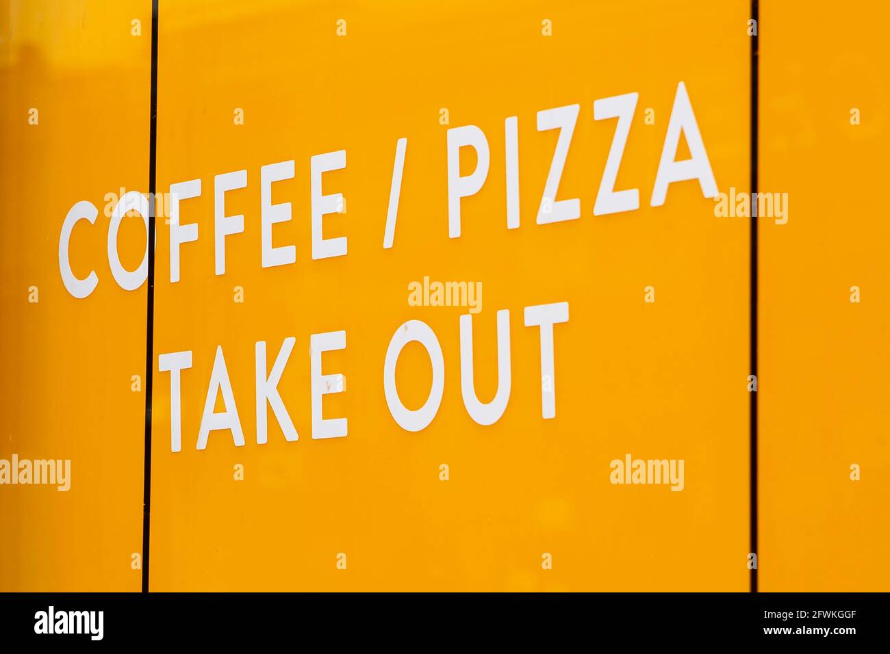 Restaurant window wording in orange Stock Photo - Alamy