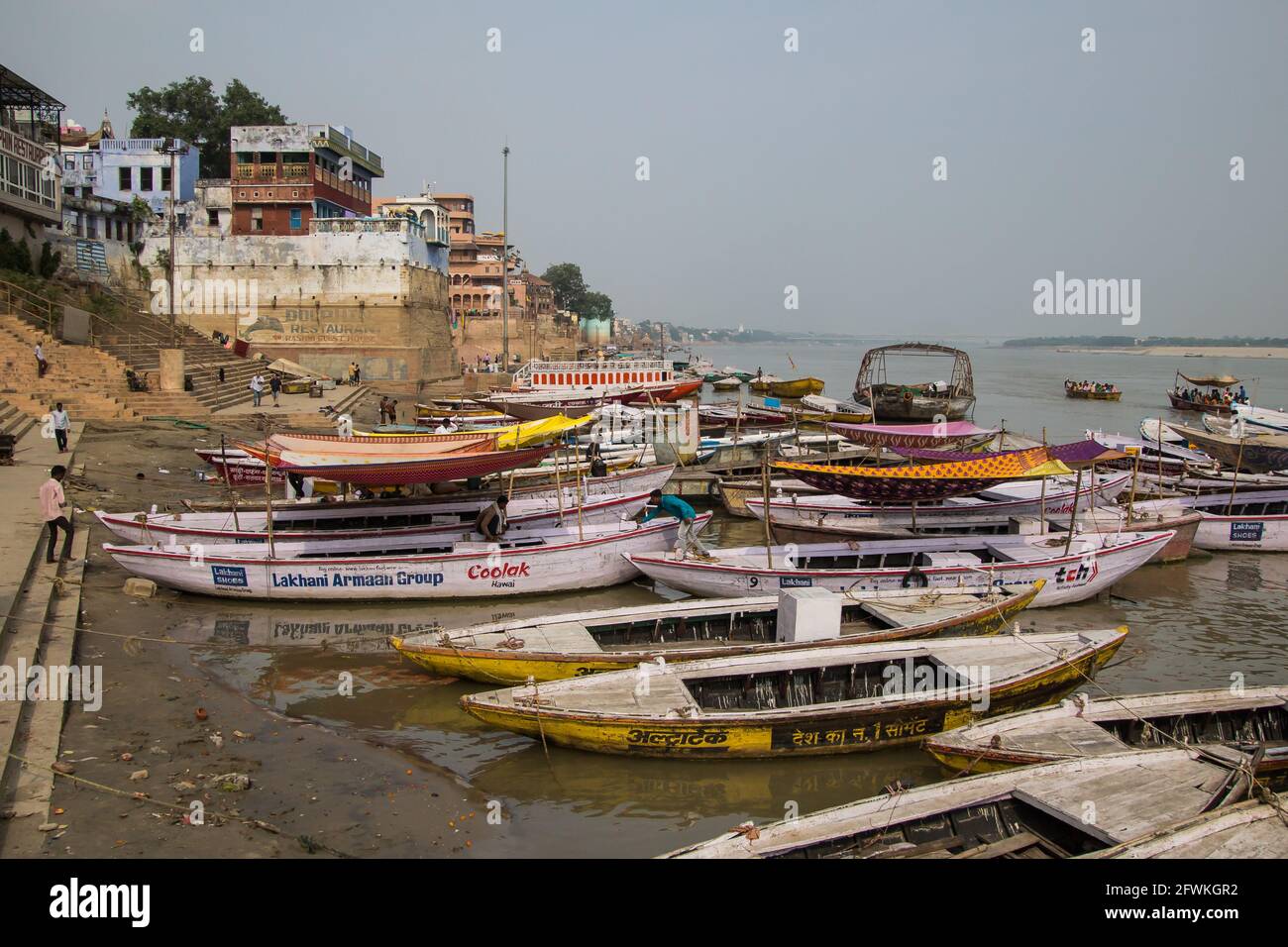 Colourful wooden boats line the banks of the River Ganges in Varanasi ...