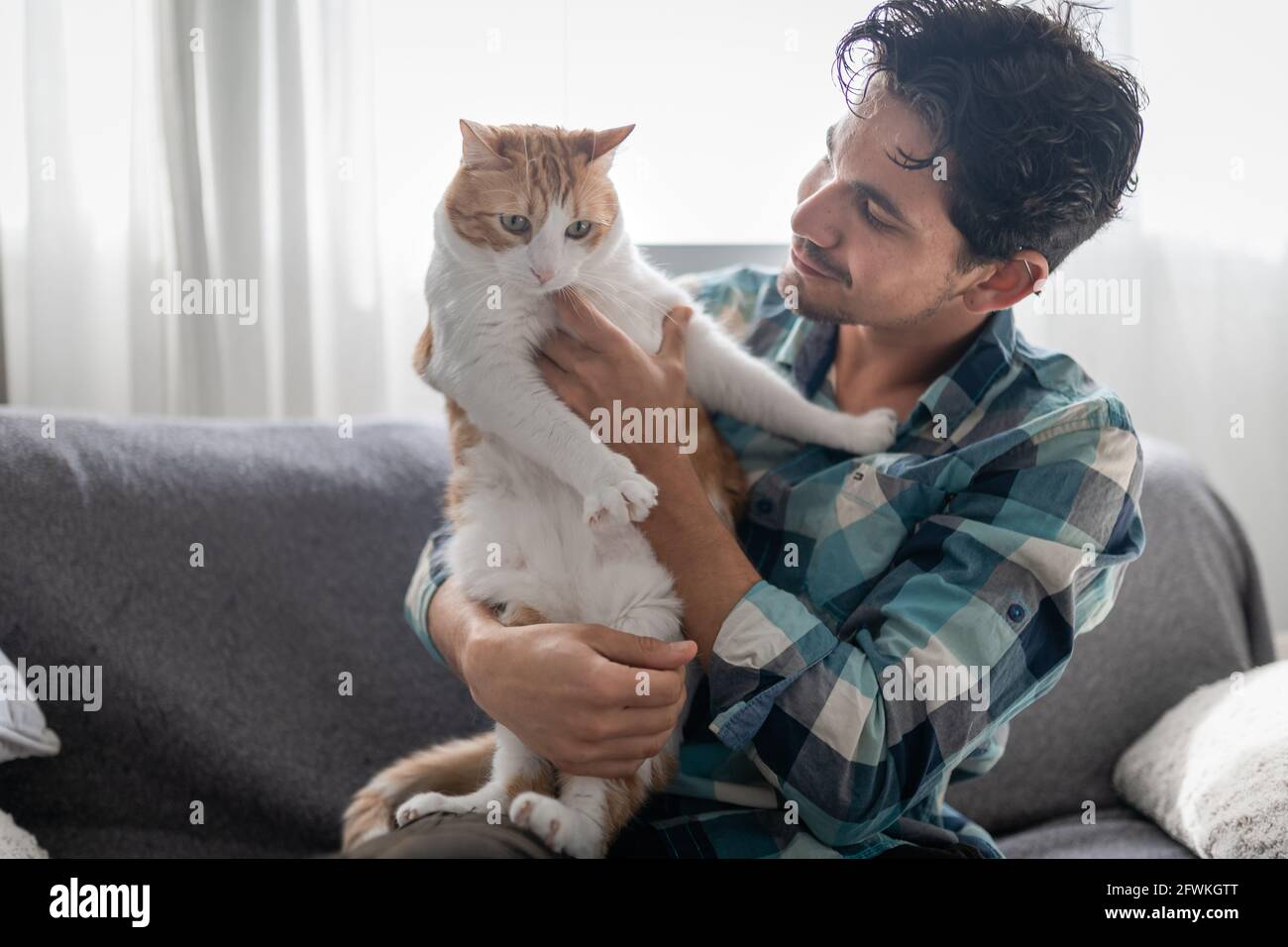 Man holding cat in arms hi-res stock photography and images - Alamy