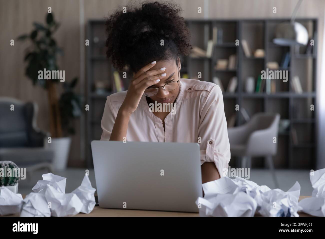 Stressed young african ethnicity woman feeling exhausted at workplace ...