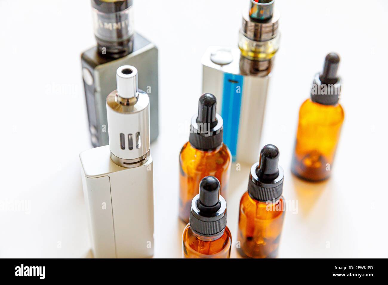 Vaping Device E Cigarette Electronic Cigarette And Liquid Bottles Isolated On White Background