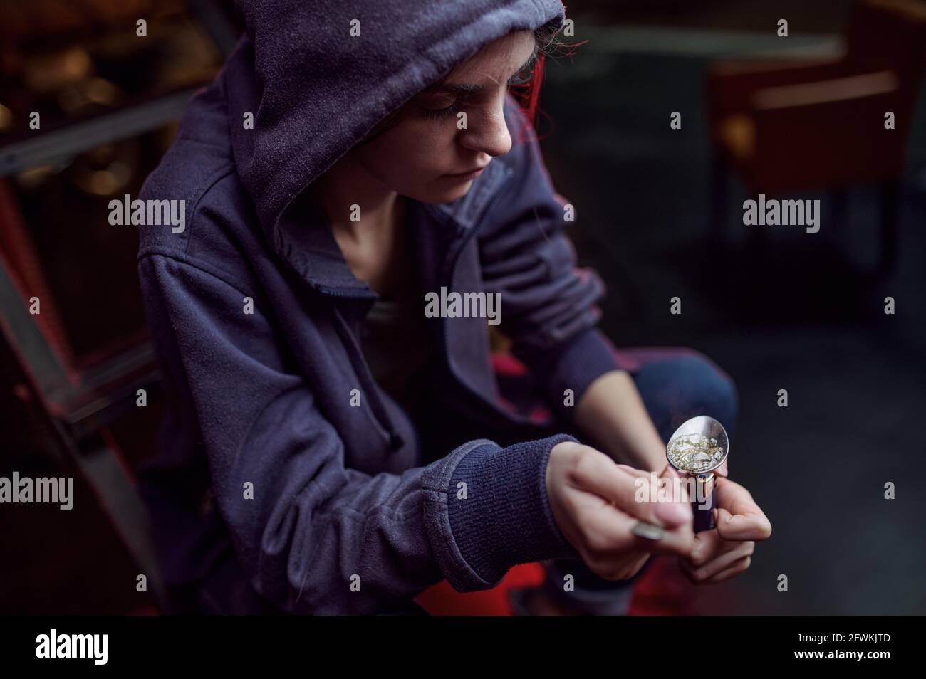 Drug addict with spoon and fire prepares dose Stock Photo - Alamy