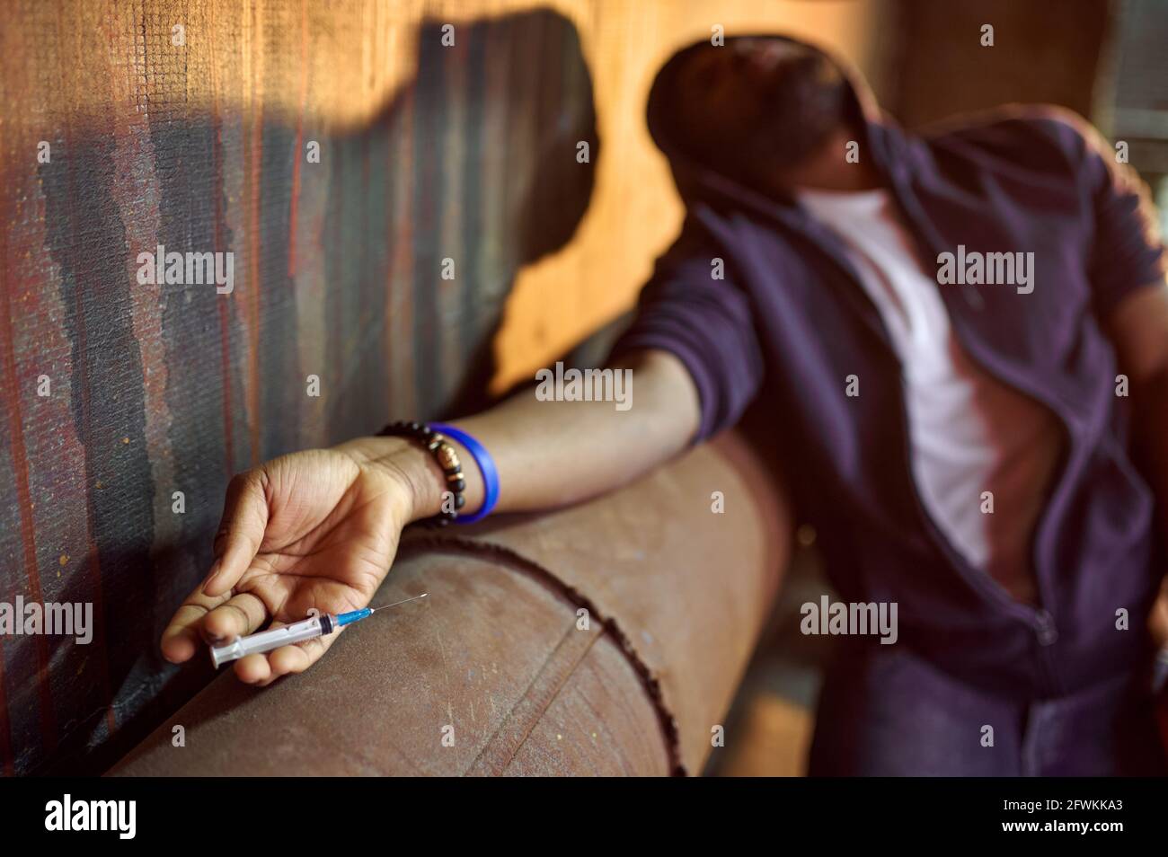 Drug addict man with syringe in high Stock Photo - Alamy