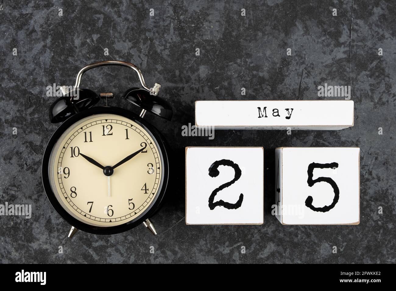 May 25th. May 25 white wooden cube calendar and alarm clock on grey ...