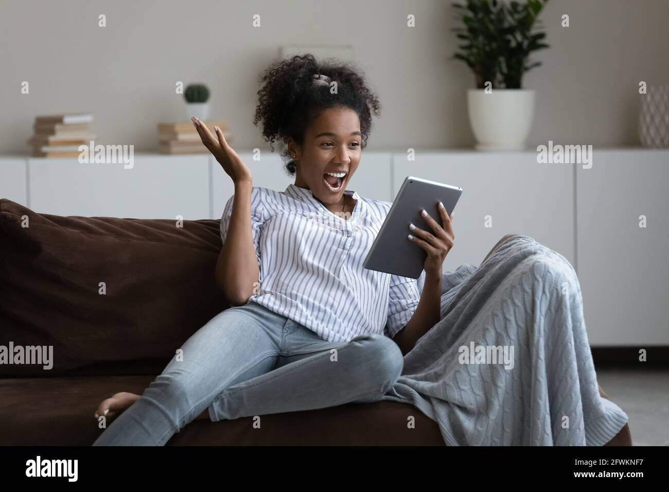 Happy young african woman feeling overjoyed at home Stock Photo - Alamy