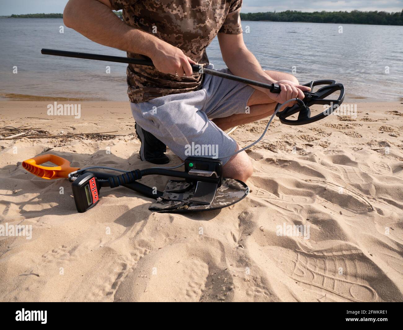 Guy on the shore getting ready for a treasure hunt with a metal ...